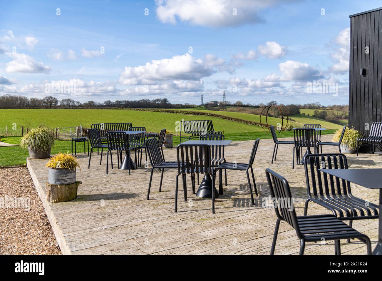 Outdoor chairs and tables for seating guests at a wedding reception ...