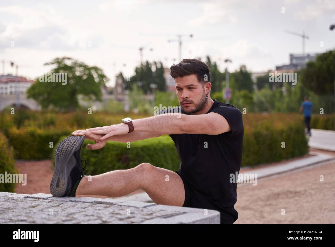 Male runner stretching outdoors in autumn forest in mountains. Standing ...