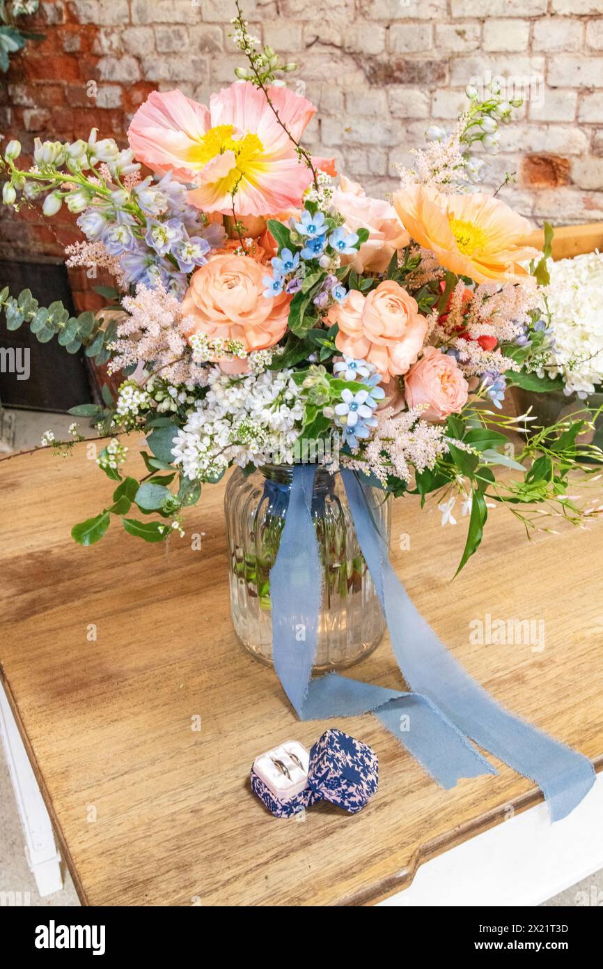 Wedding rings on display with a flower bouquet on a table at Botley ...