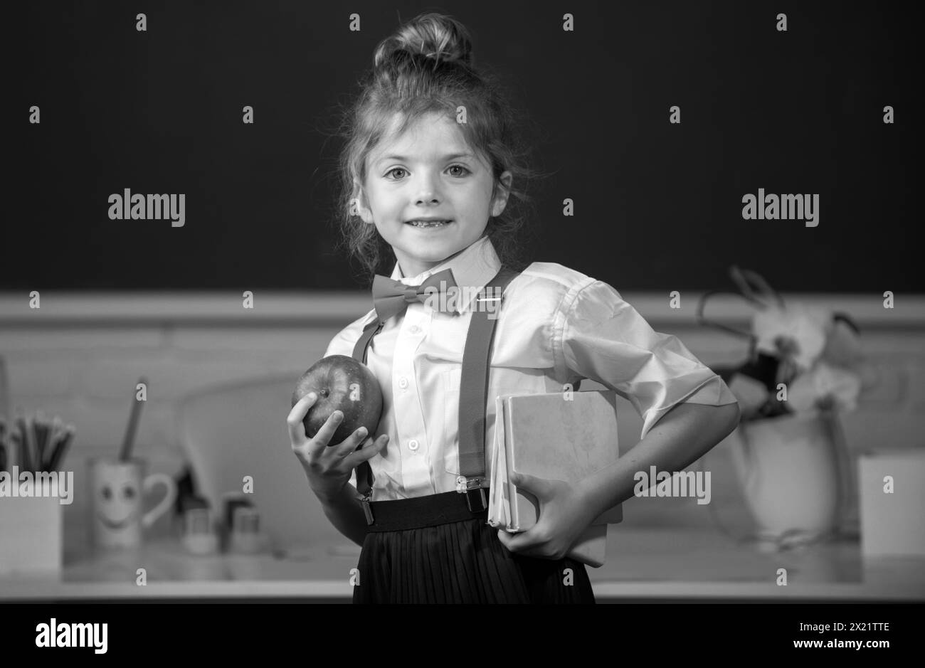 Cute child at school. Kid is learning in class on background of ...