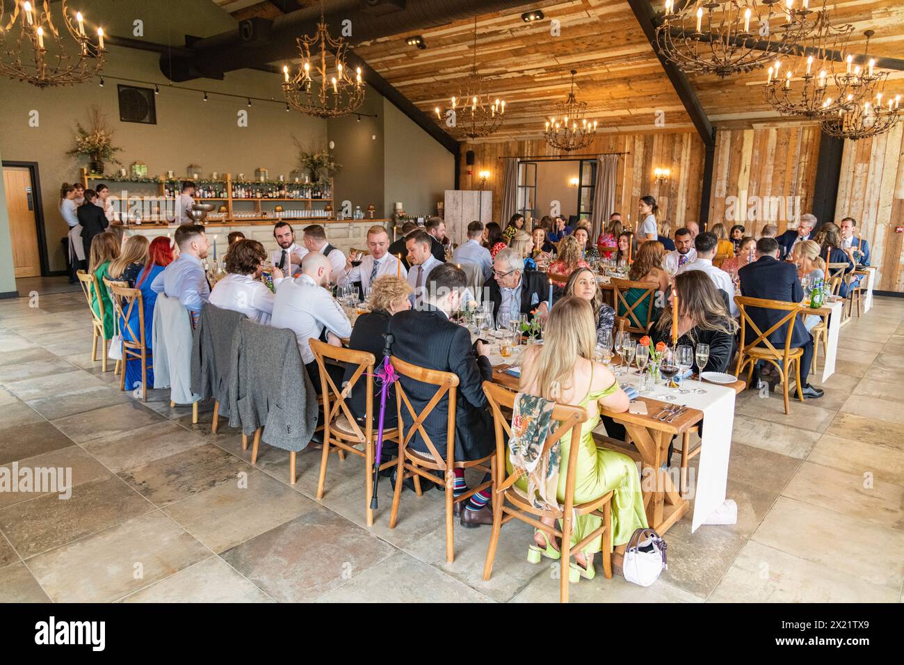 Wedding guests friends and family sat at a wedding table during a ...