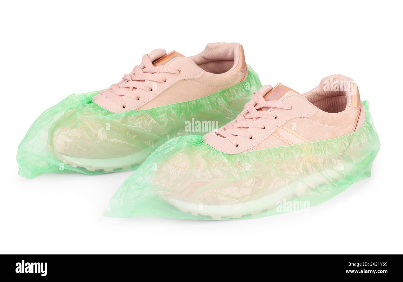 Sneakers in green shoe covers isolated on white Stock Photo - Alamy