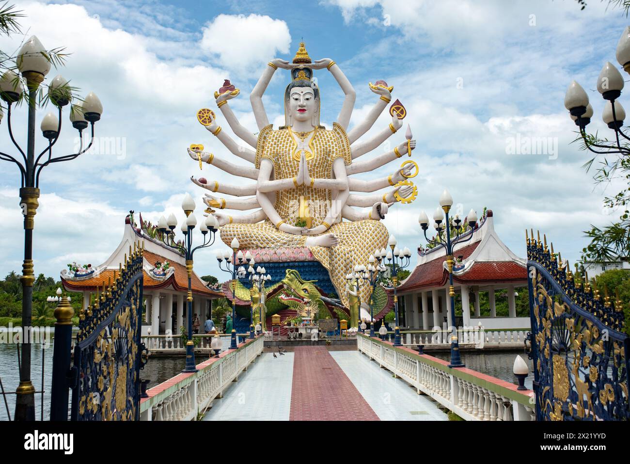 Wat Plai Laem's iconic Buddha statue with multiple arms extends a ...