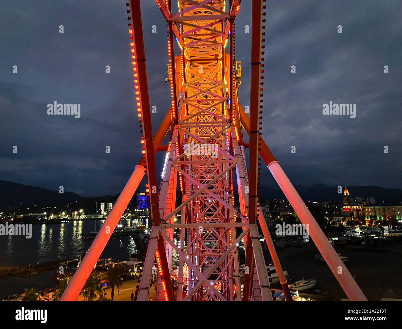 Ferris wheel in amusement park, large metal structure on night city and ...