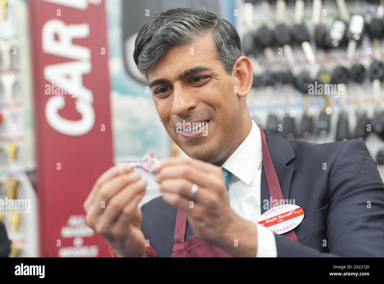 Prime Minister Rishi Sunak looks at a key after operating a cylinder ...