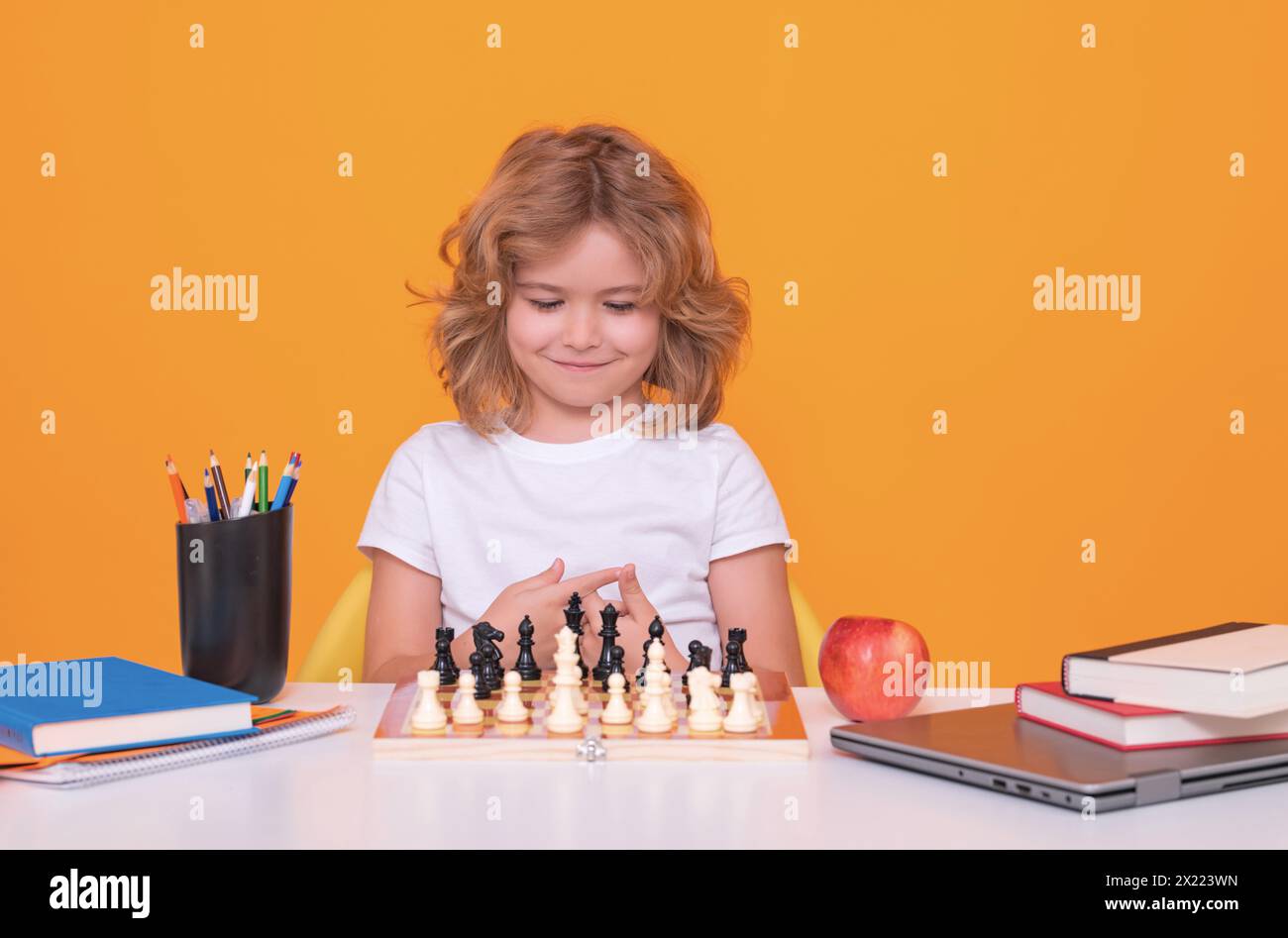Child play chess on studio background. Kid playing chess. Clever child ...
