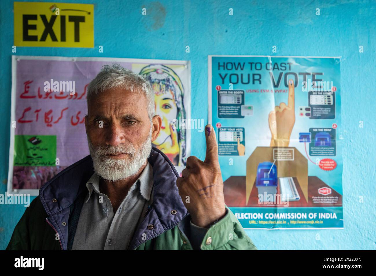 A man shows an ink-marked finger after casting his vote outside a ...