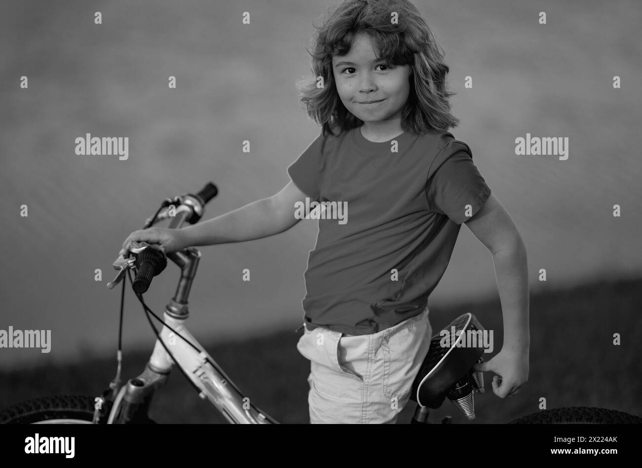 Child riding bicycle. Little kid boy on bicycle along bikeway. Happy ...