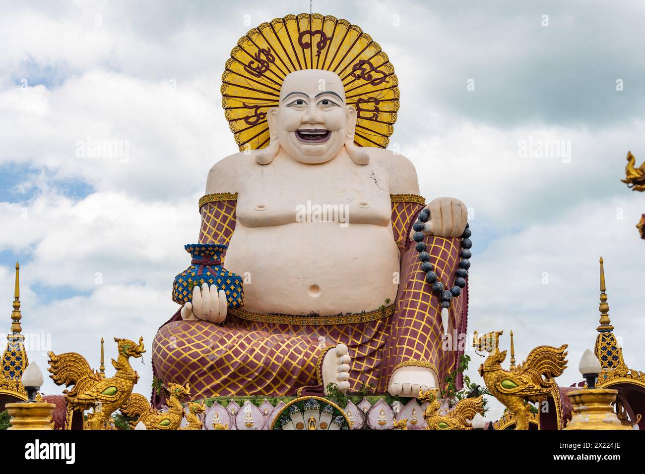 A close view of a joyful Laughing Buddha statue with a detailed halo ...