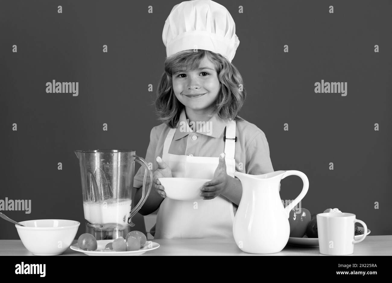 Child chef isolated on blue. Funny little kid chef cook wearing uniform ...