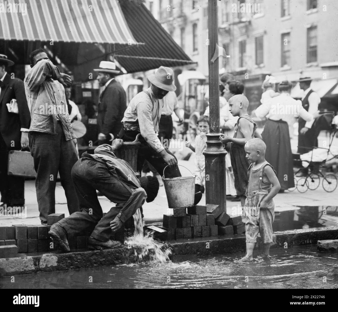 Summer scene, N.Y. - drinking water from street pump, between c1910 and ...