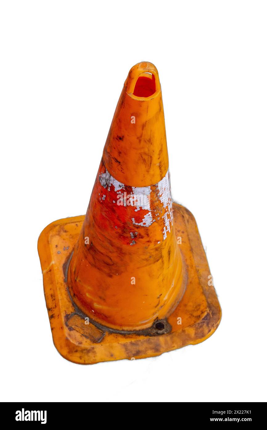 An isolated, battered traffic cone, showing signs of wear and tear ...