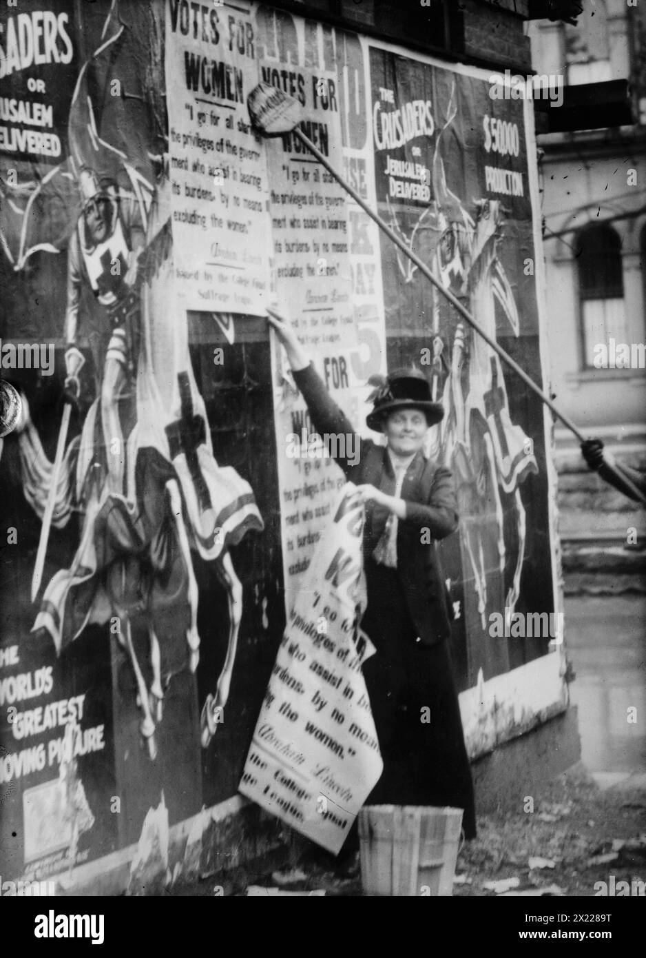 Miss Louise Hall with brush and Susan Fitzgerald assisting bill posting ...