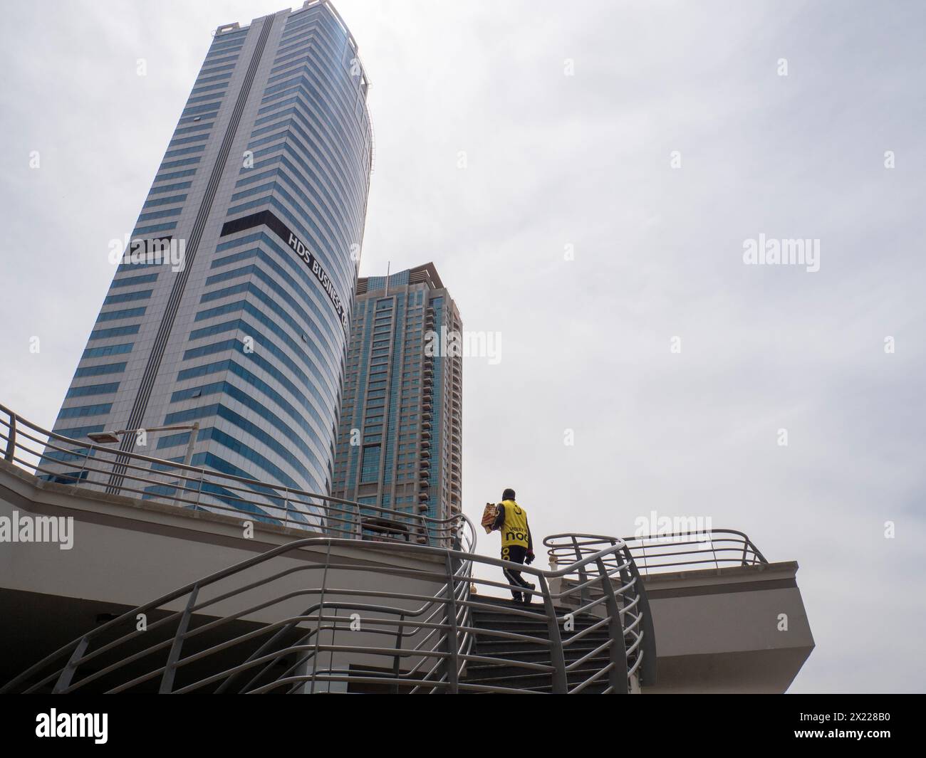Noon Food worker walking up stairs in front of HDS Business Center ...