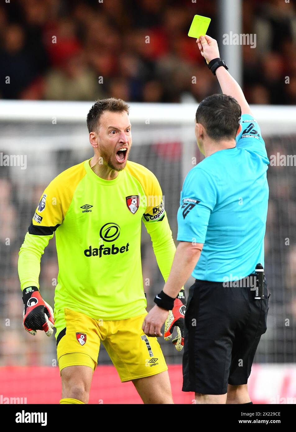 Neto of AFC Bournemouth is shown a yellow card by referee Tony ...