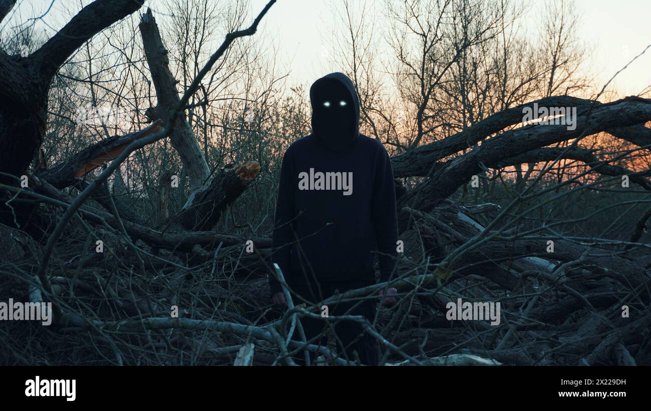 A horror concept of a supernatural demon like entity with glowing eyes ...