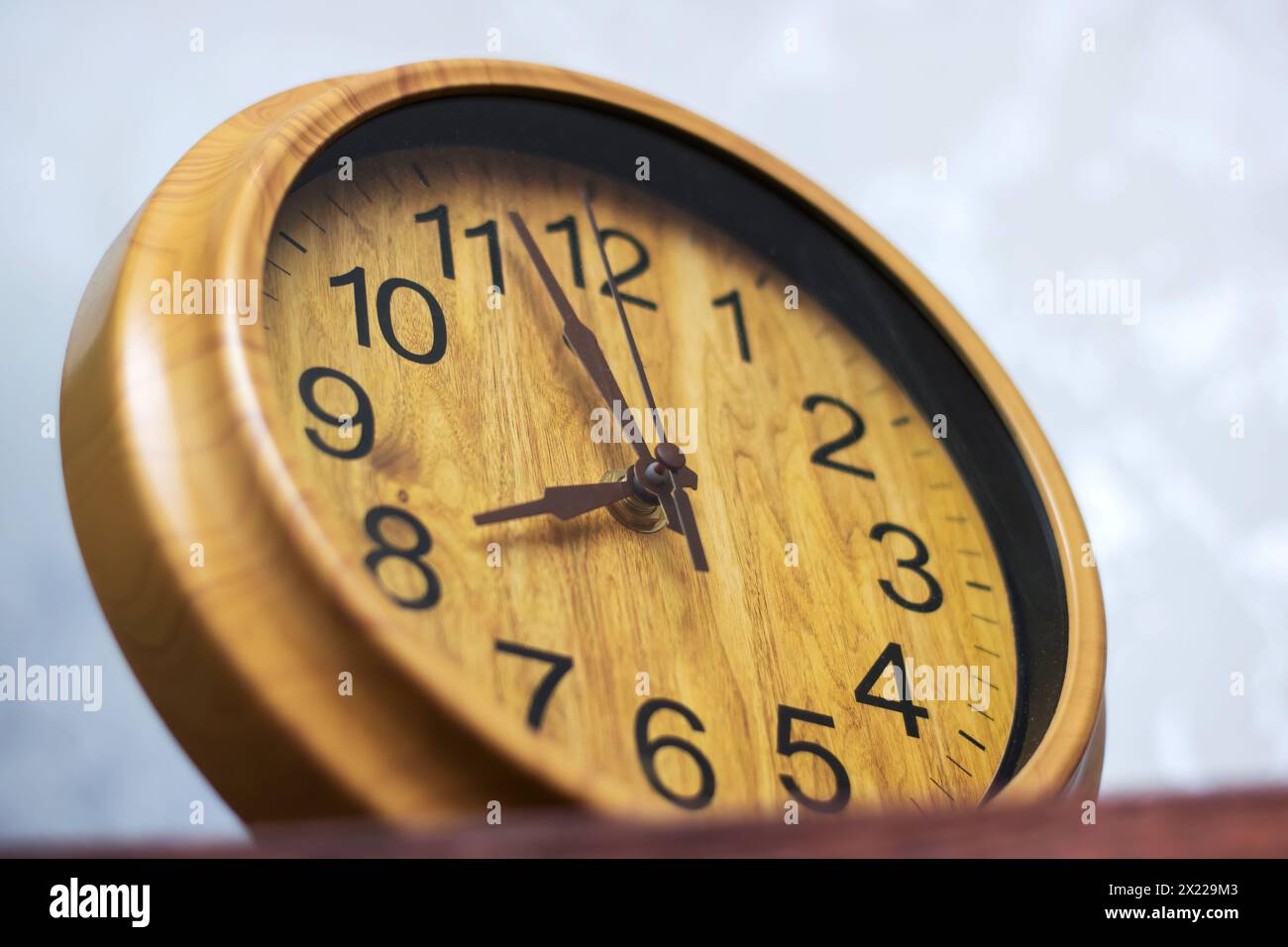 A close up of a wooden clock measuring instrument showing the time ...