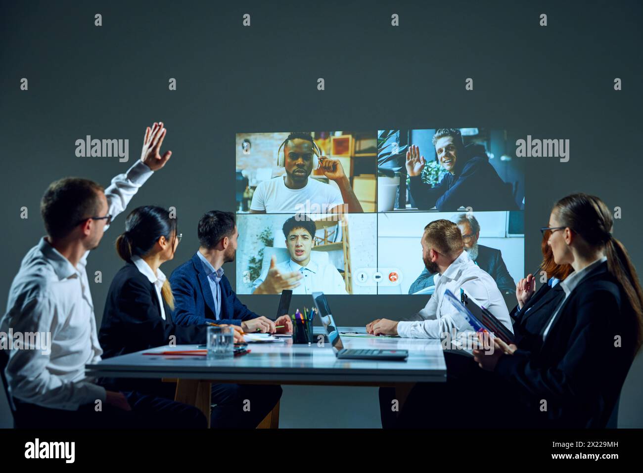 Office workers, colleagues gather around conference table, engaged in ...