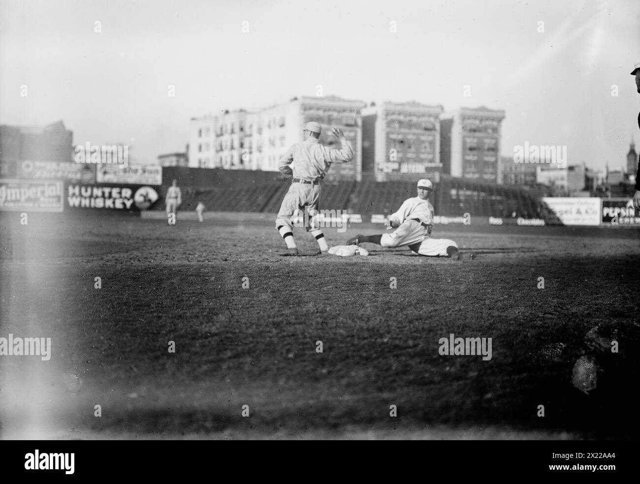 Guy Zinn, New York AL, sliding back into first base against Boston at ...