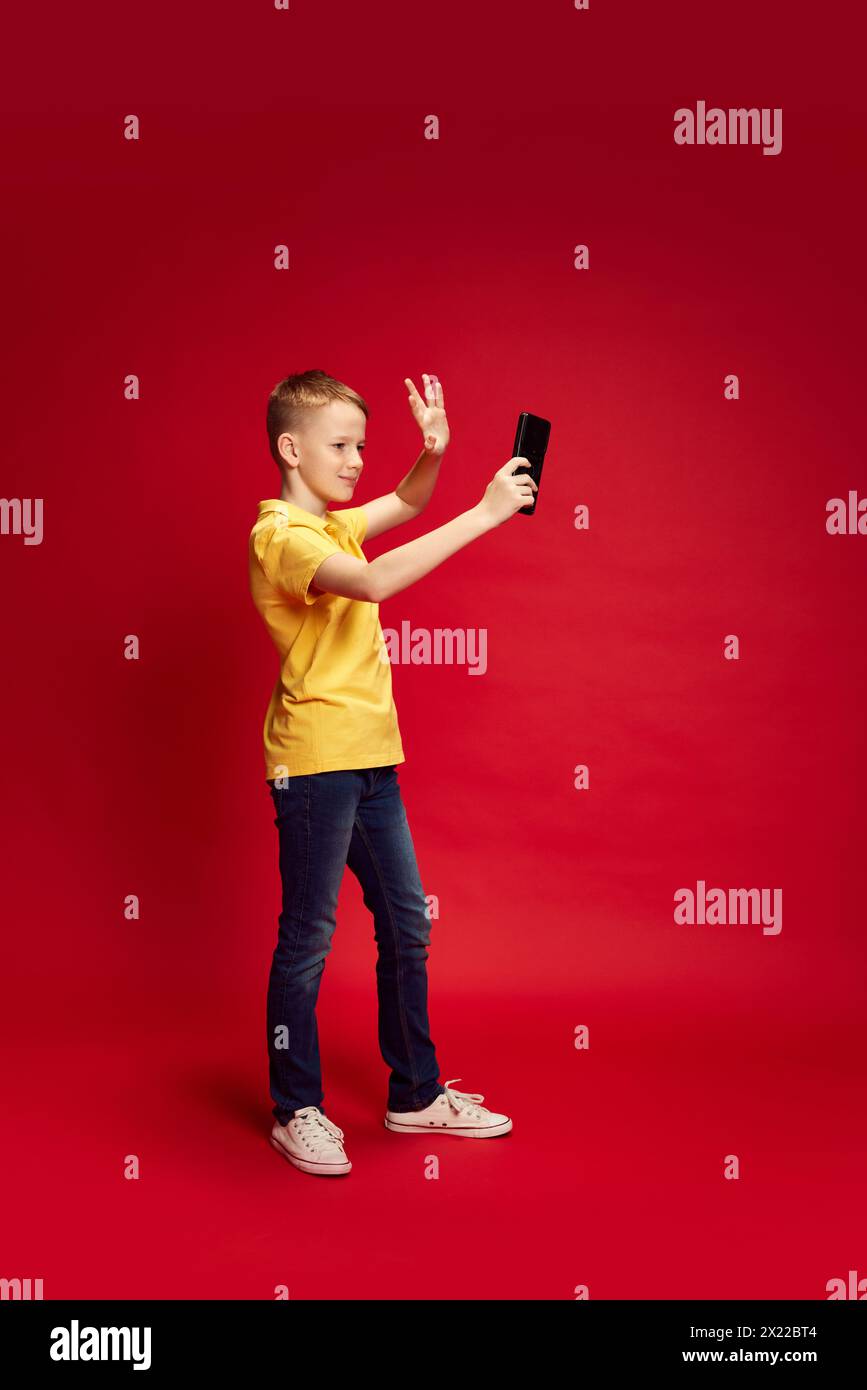 Portrait of teenage boy, school-boy waving hello while talking with ...