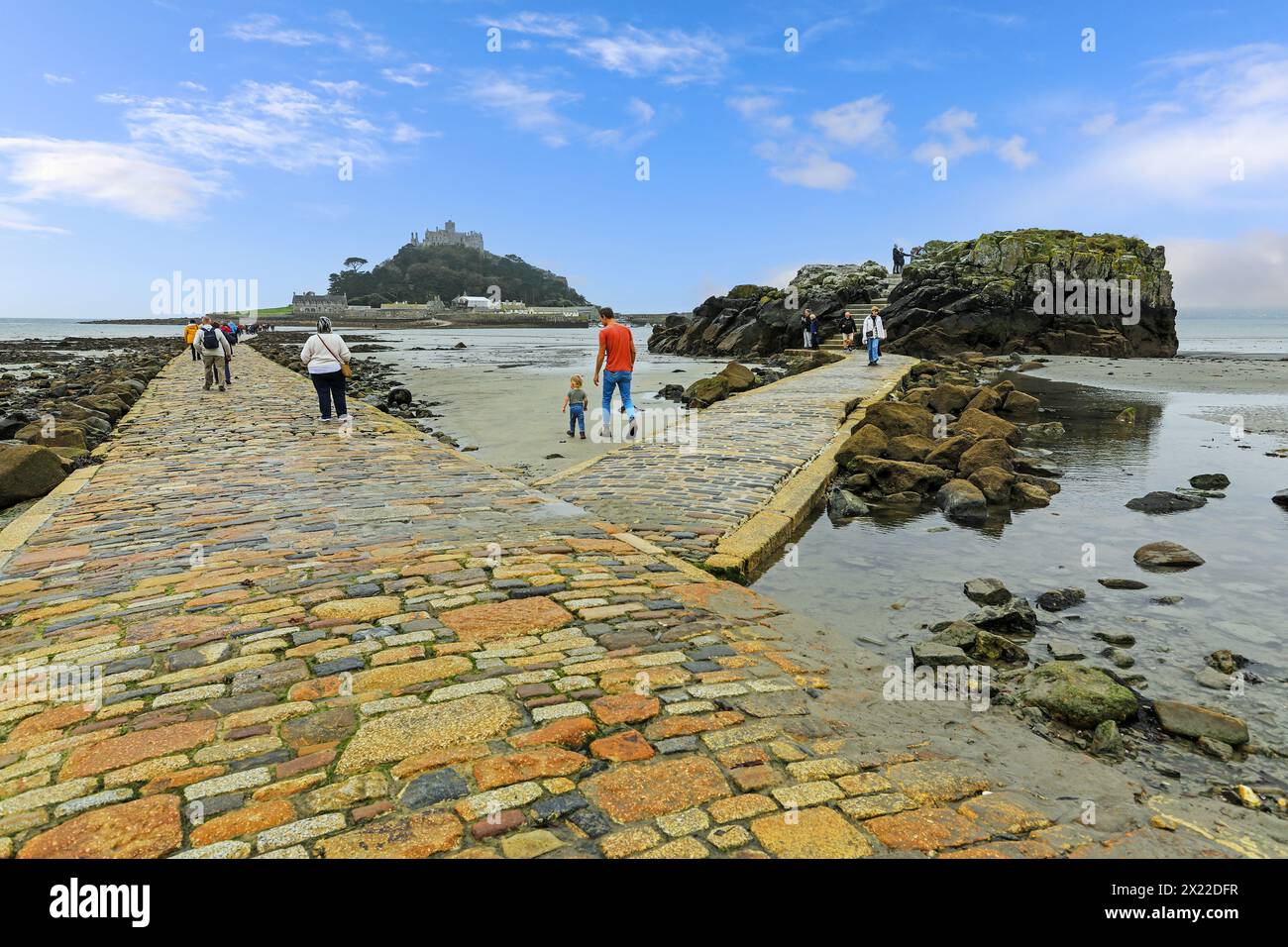 Tourists walking on the tidal causeway to St Michael's Mount, a tidal ...