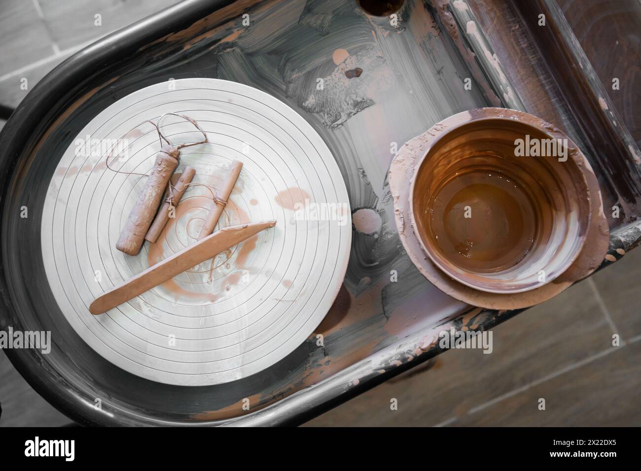 Close up view of string cutter and pottery tools . pottery, workshop ...