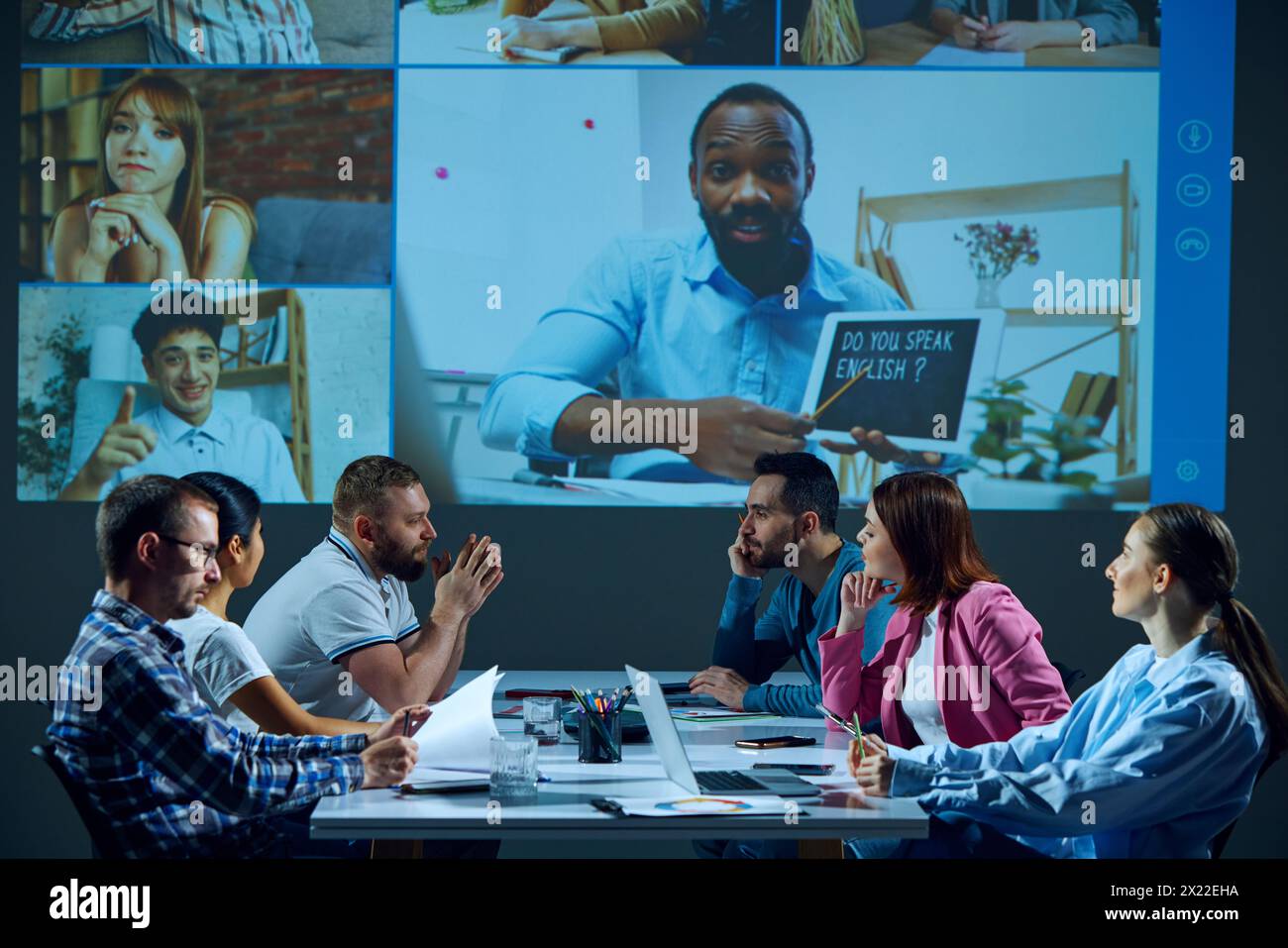 Office employees gather in the conference room, having online video ...