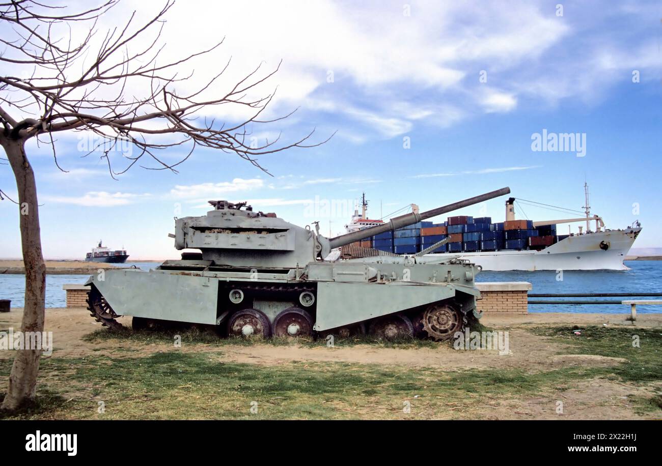 Old rusty armor tank alongside the Suez canal in Egypt with passing ...
