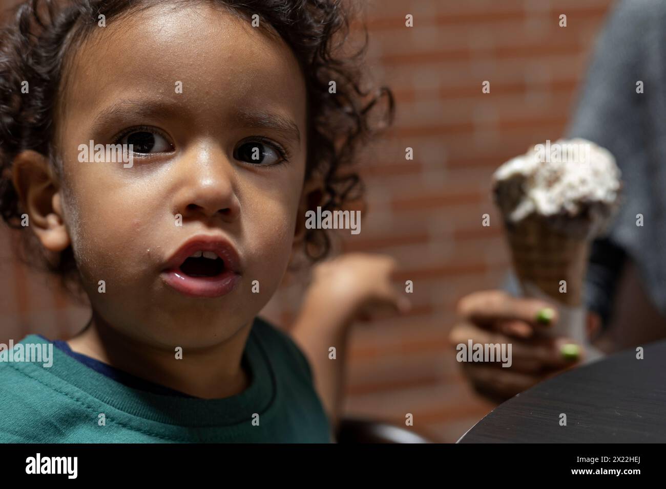 Mom And Her Latin American Son Sharing An Ice Cream Motherhood And
