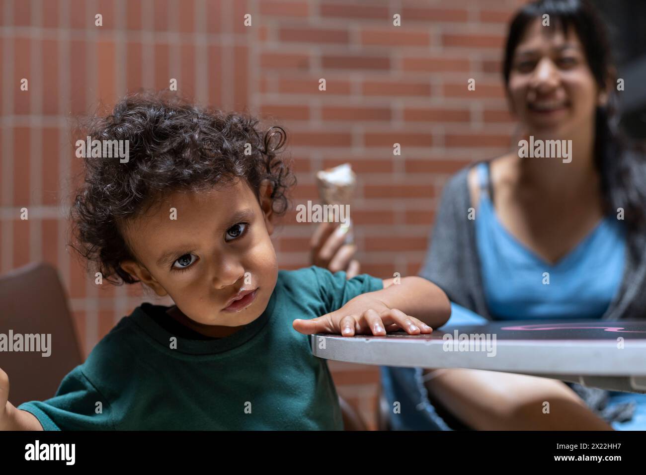Mom And Her Latin American Son Sharing An Ice Cream Motherhood And