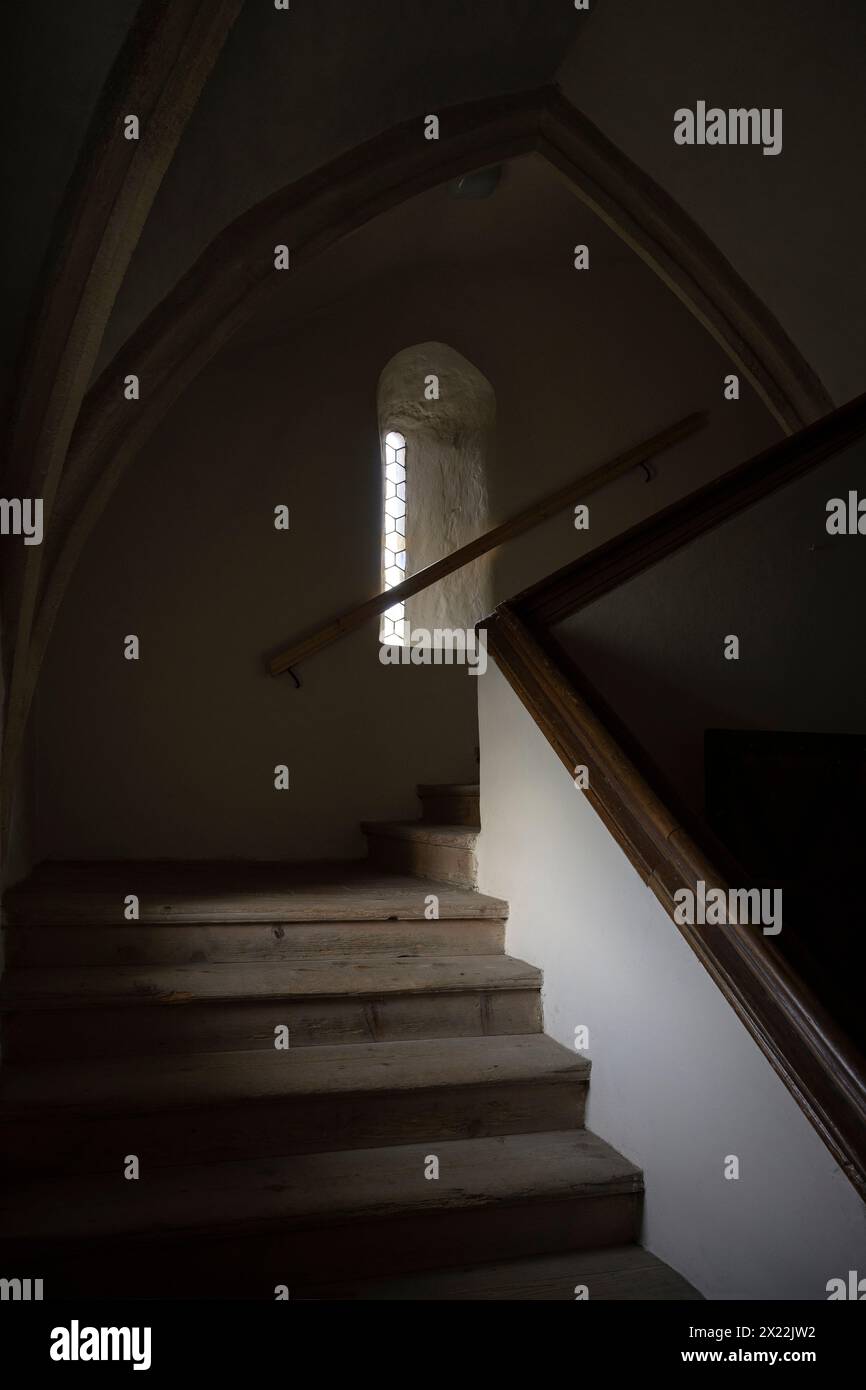 Wooden stairs and Gothic cross vaults lead up to the organ of the ...