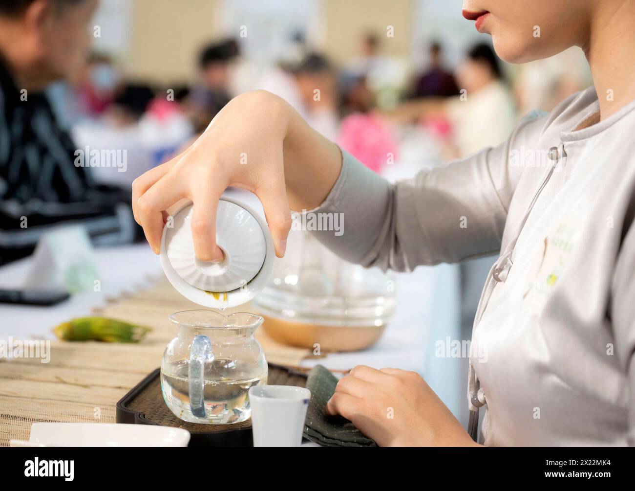 Beijing, China. 19th Apr, 2024. A tea sommelier serves tea for visitors ...