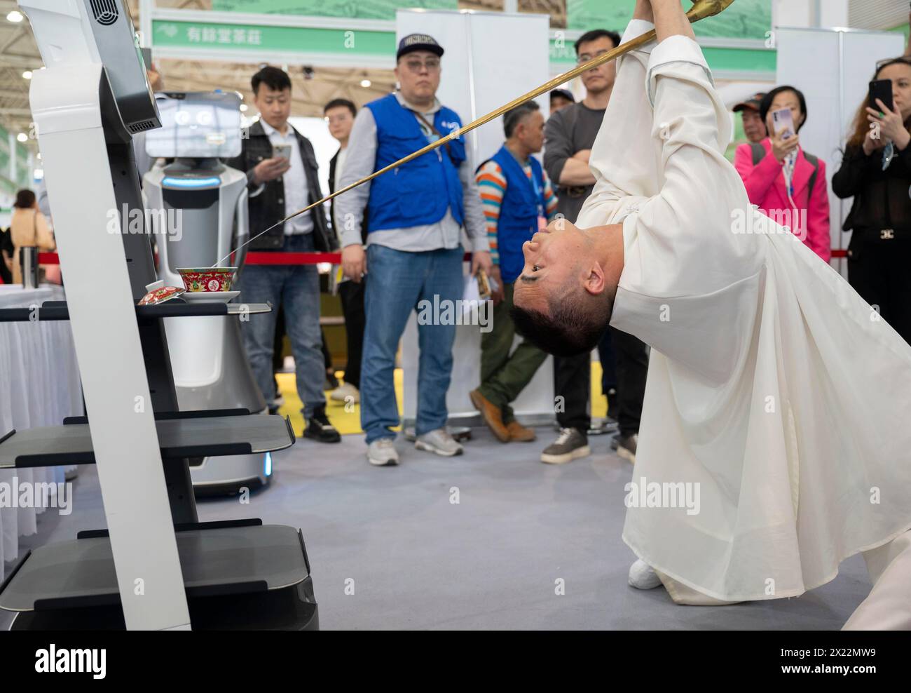 Beijing, China. 19th Apr, 2024. A man demonstrates skills of pouring ...