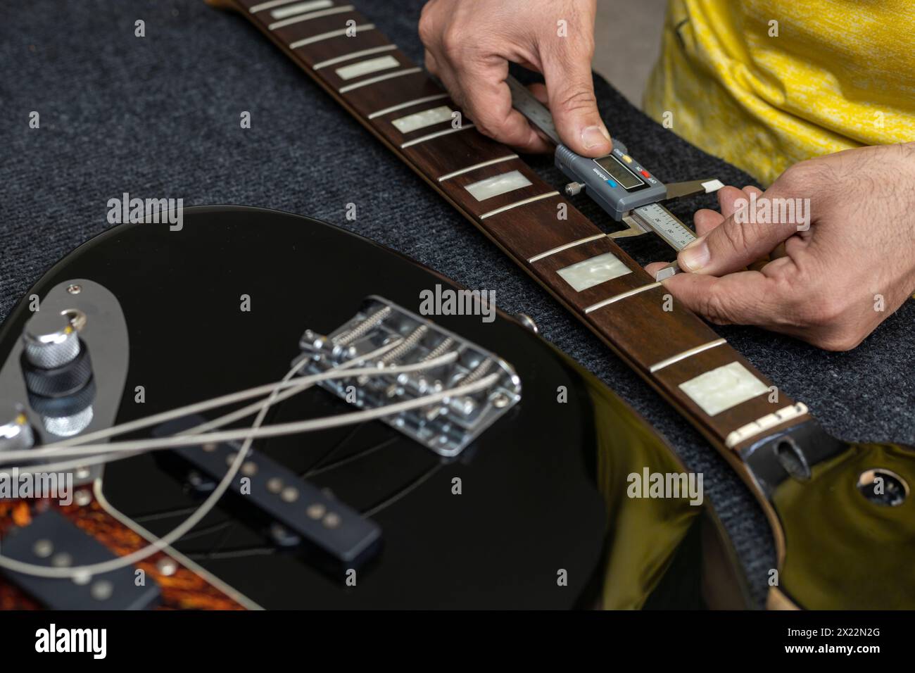 Latin American luthier takes accurate measurements of the distance of ...