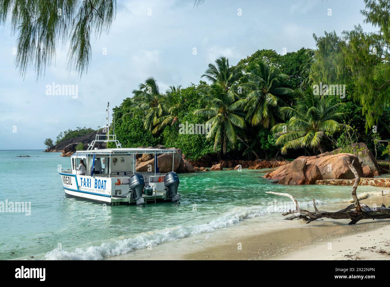 Taxi boat on a beach in Praslin island, Seychelles Stock Photo - Alamy