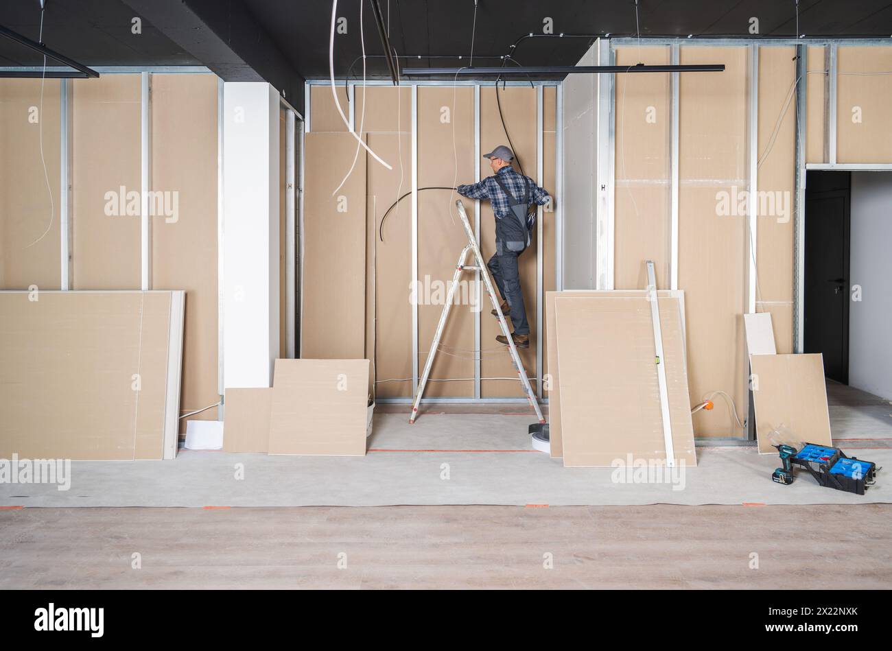 Caucasian Professional Electrician Contractor Installing Electric Cable ...