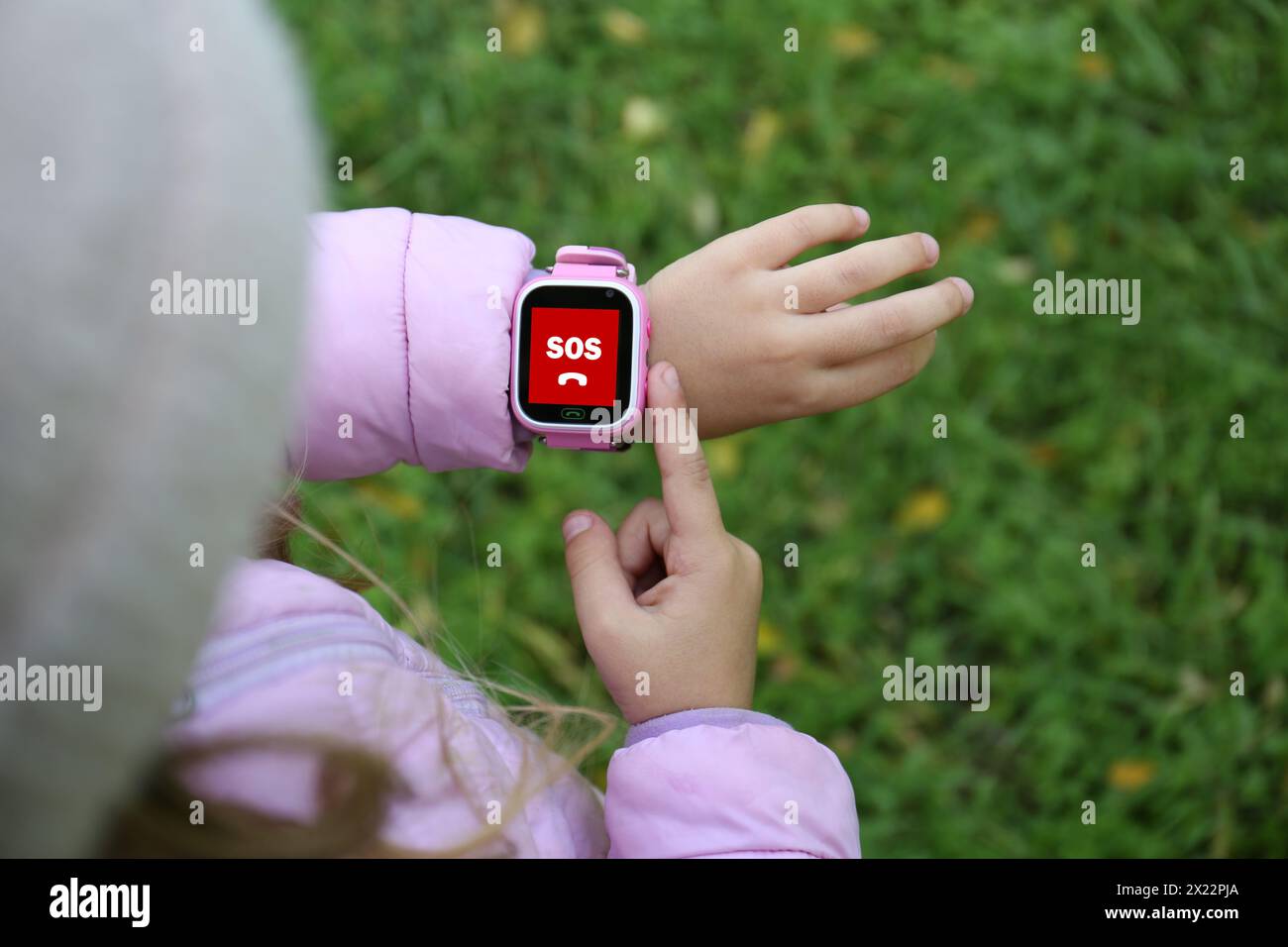 Little girl using SOS function on smartwatch outdoors, closeup Stock ...
