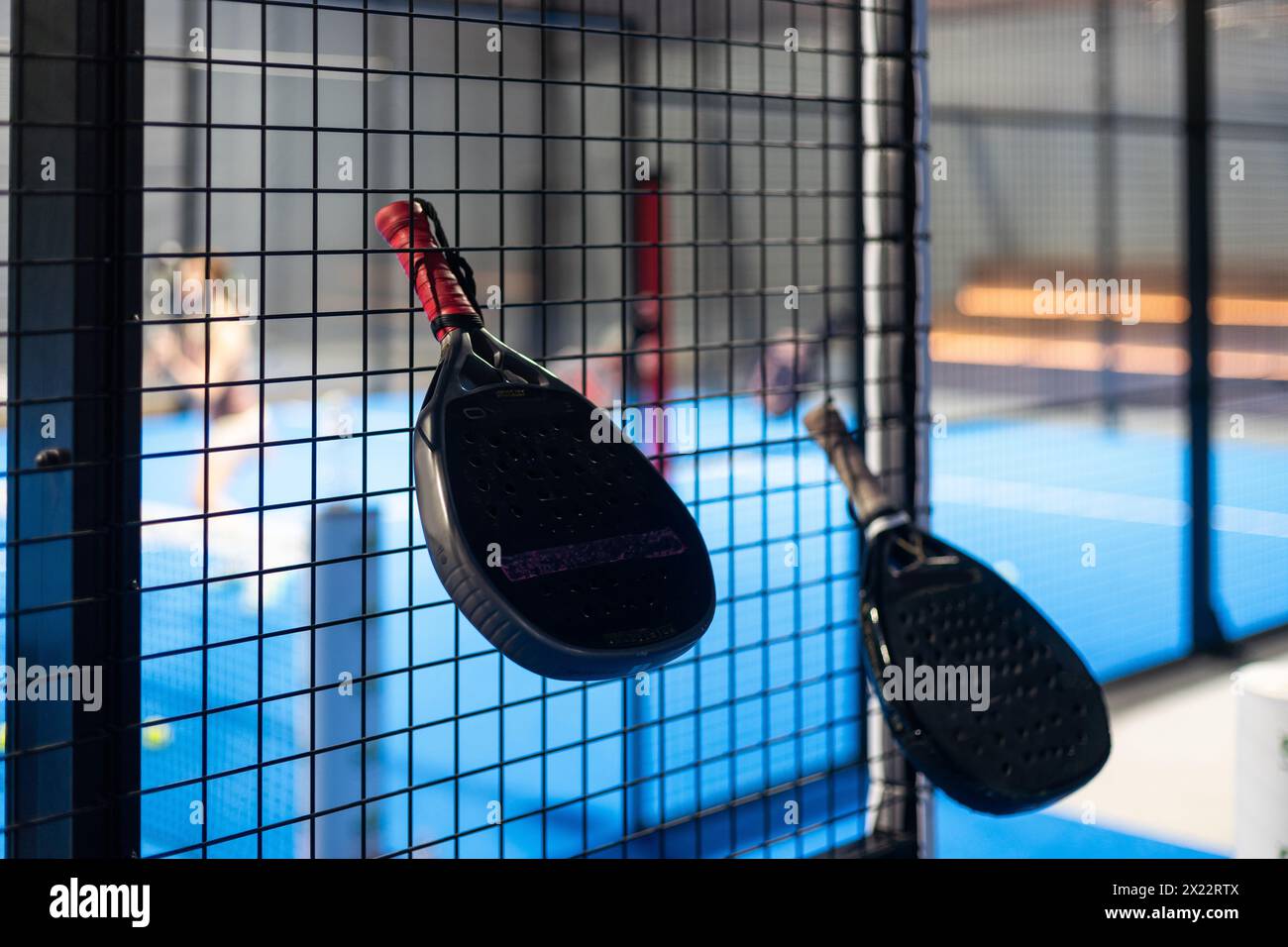 Paddle tennis: Padel racket and ball in front of an outdoor court Stock ...