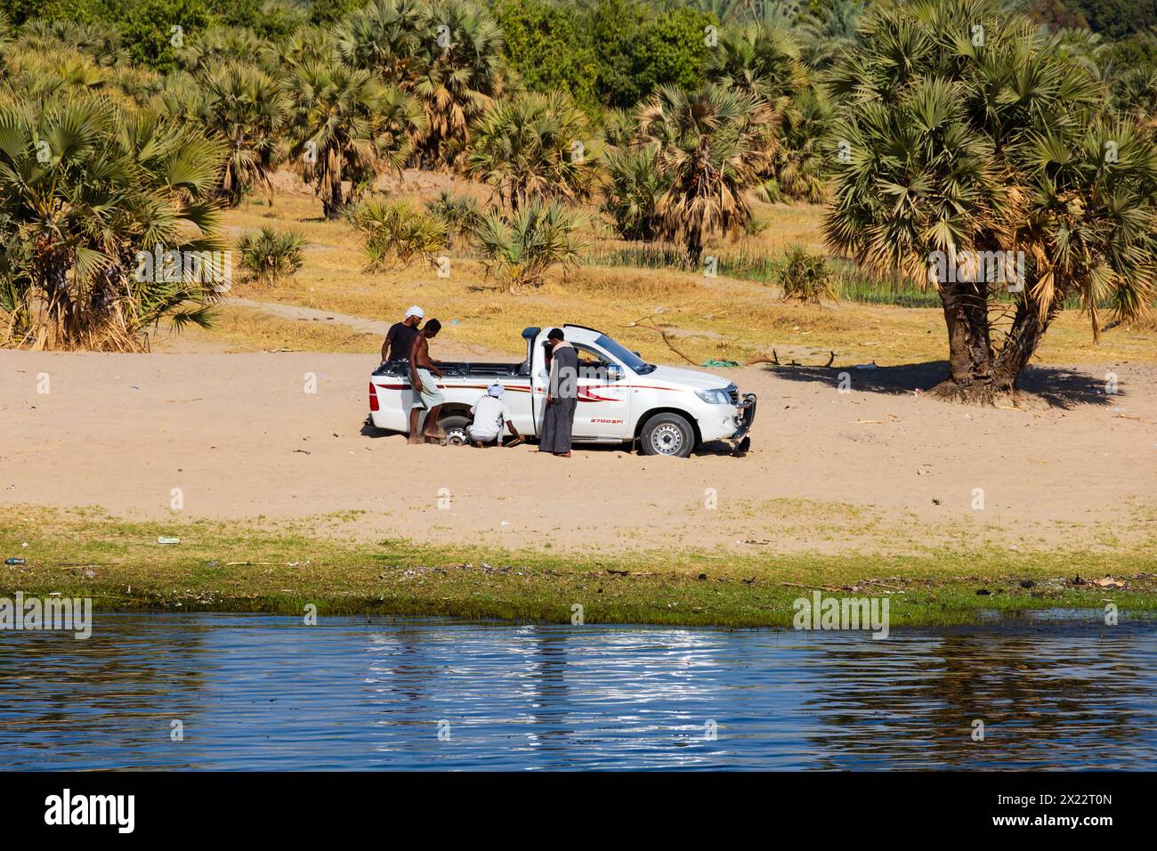 Four Egyptian men with a bogged in Toyota Hilux pickup truck, on the ...