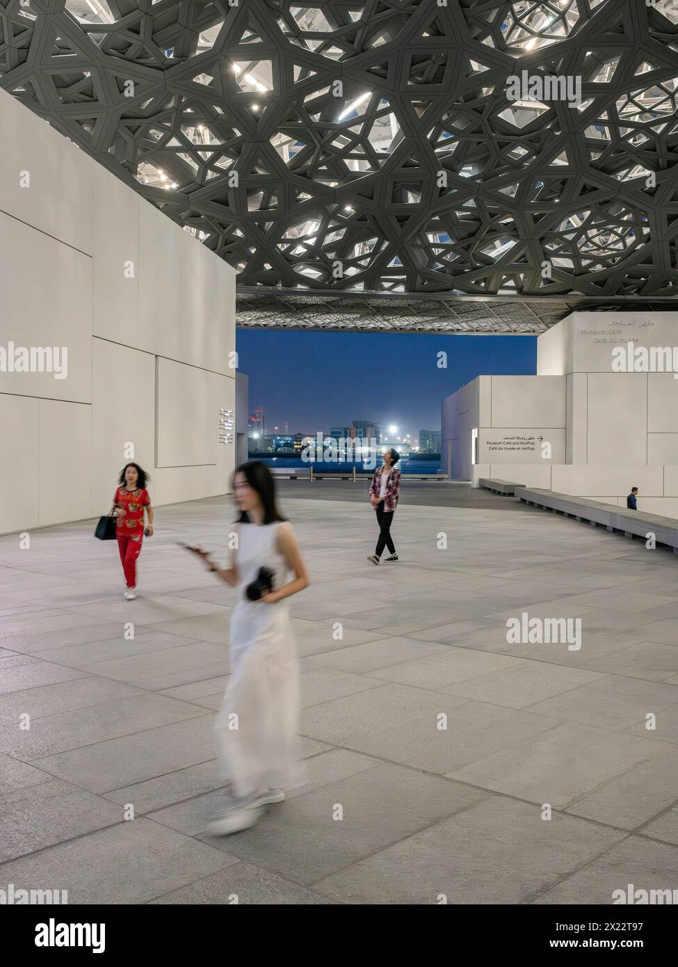 Circulation space underneath dome structure at dusk. Louvre Abu Dhabi ...