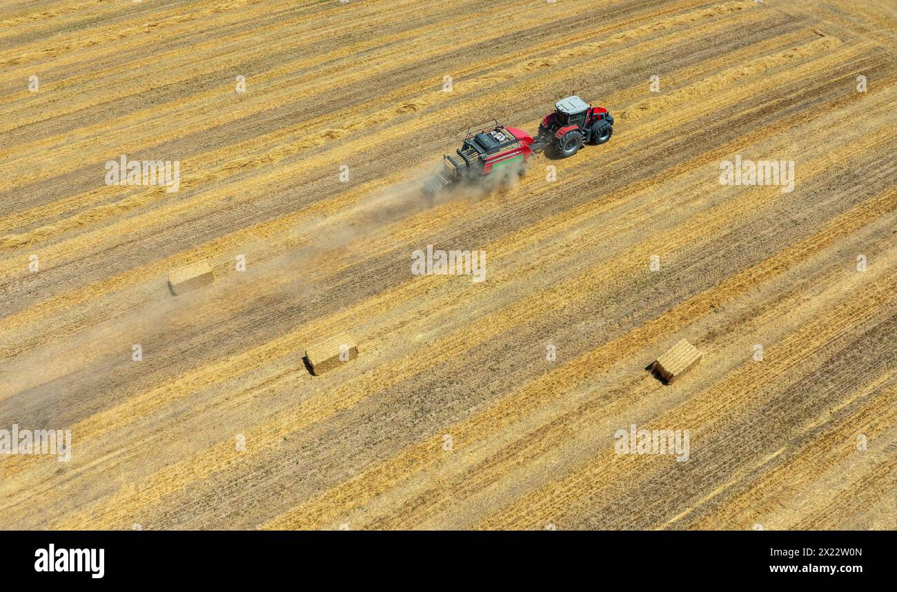Farm field, farmers work with tractor on farmland Stock Photo - Alamy