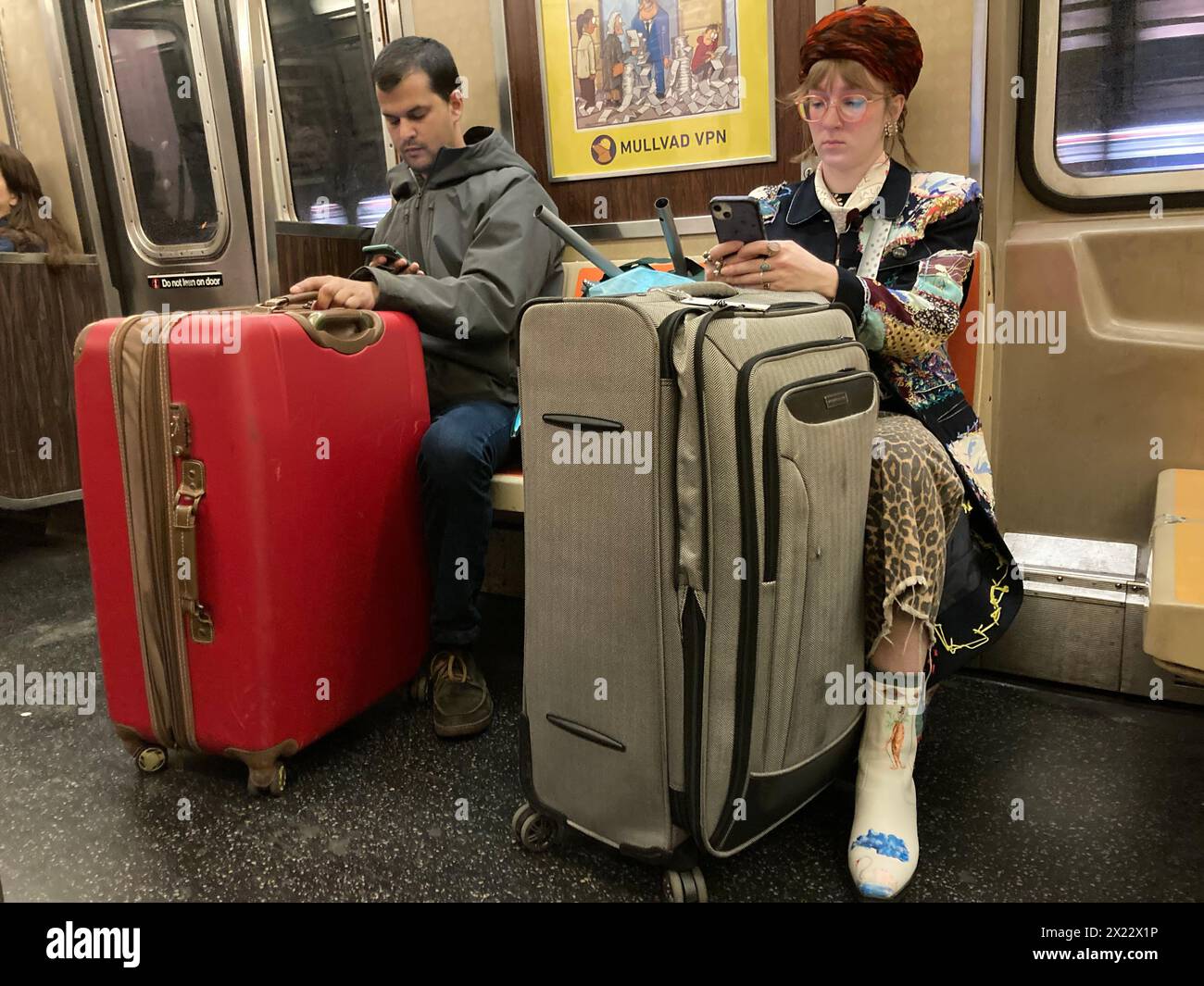 Subway riders with their luggage in New York on Sunday, April 14, 2024 ...