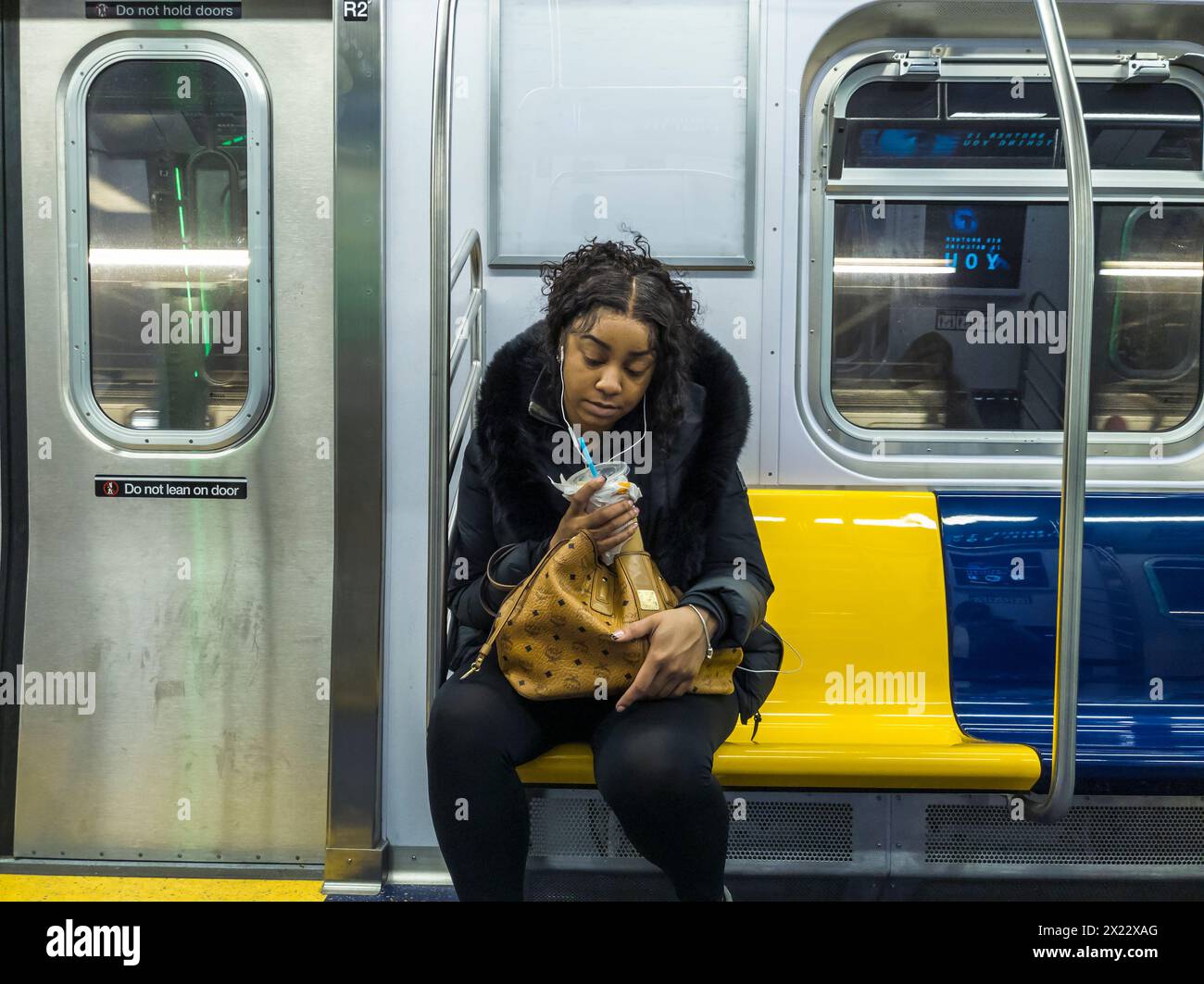 A woman sits in the priority seating on an R211 “A” train car in the ...