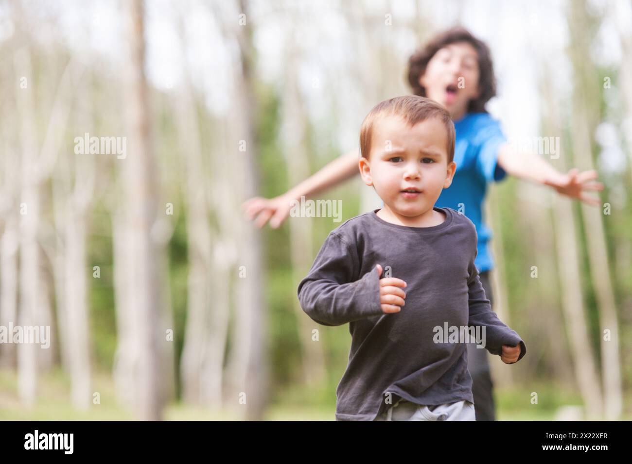 Two boys running forest hi-res stock photography and images - Alamy