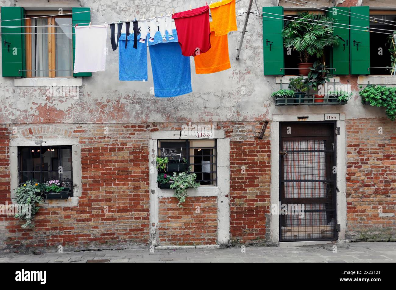 Colourful laundry hanging on a washing line in front of old Venetian ...