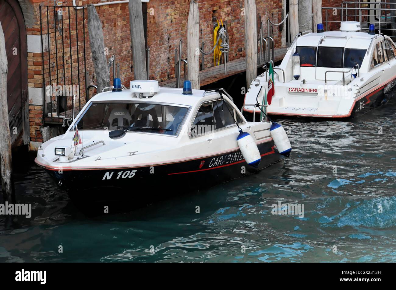 Boats of the Italian water police Carabinieri sailing through a canal ...