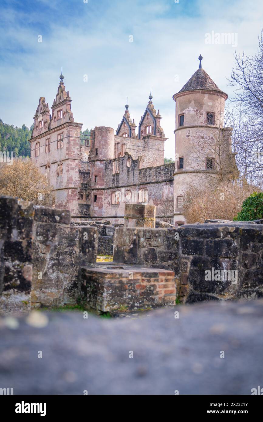 Medieval castle ruins in front of a clear sky, seen over a stone wall ...