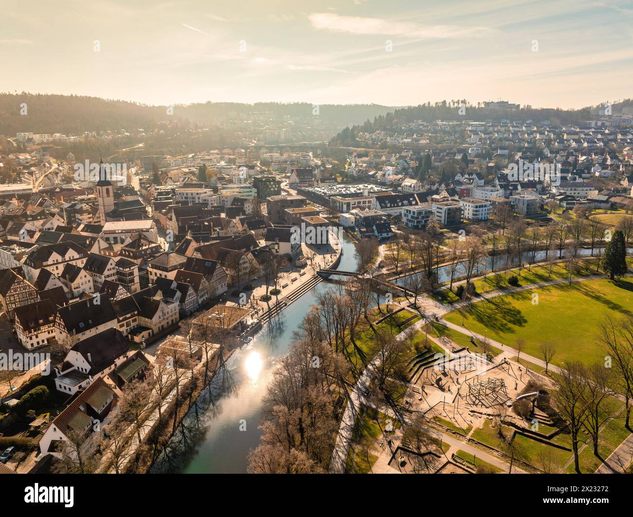 Aerial view of a river town with bridges and a church, surrounded by ...