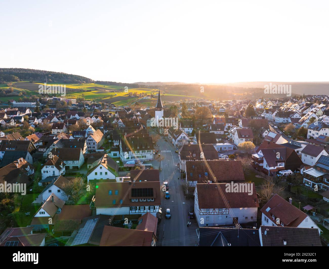 A peaceful village is bathed in the golden light of sunset, Calw, Black ...
