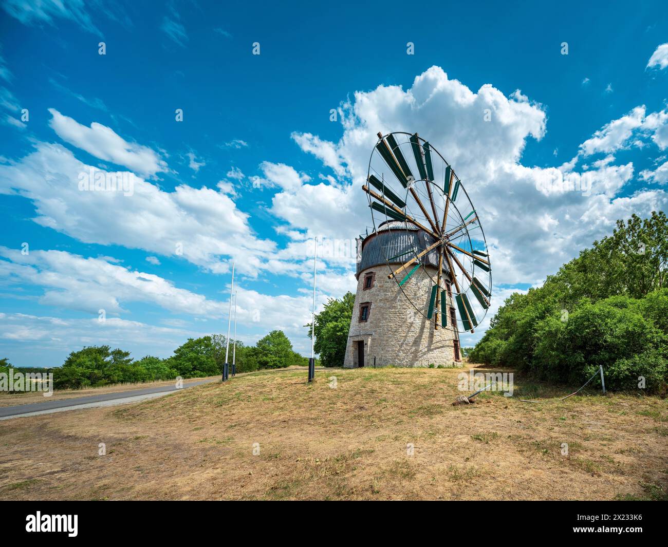 Old windmill under a clear blue sky with white clouds, tower windmill ...